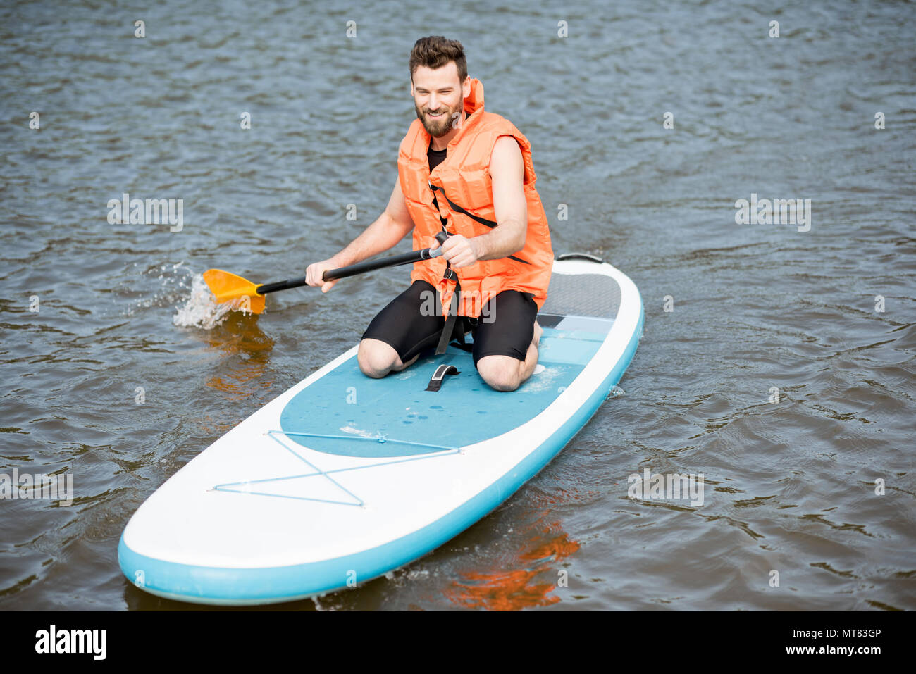 Man swimming on the paddleboard Stock Photo - Alamy