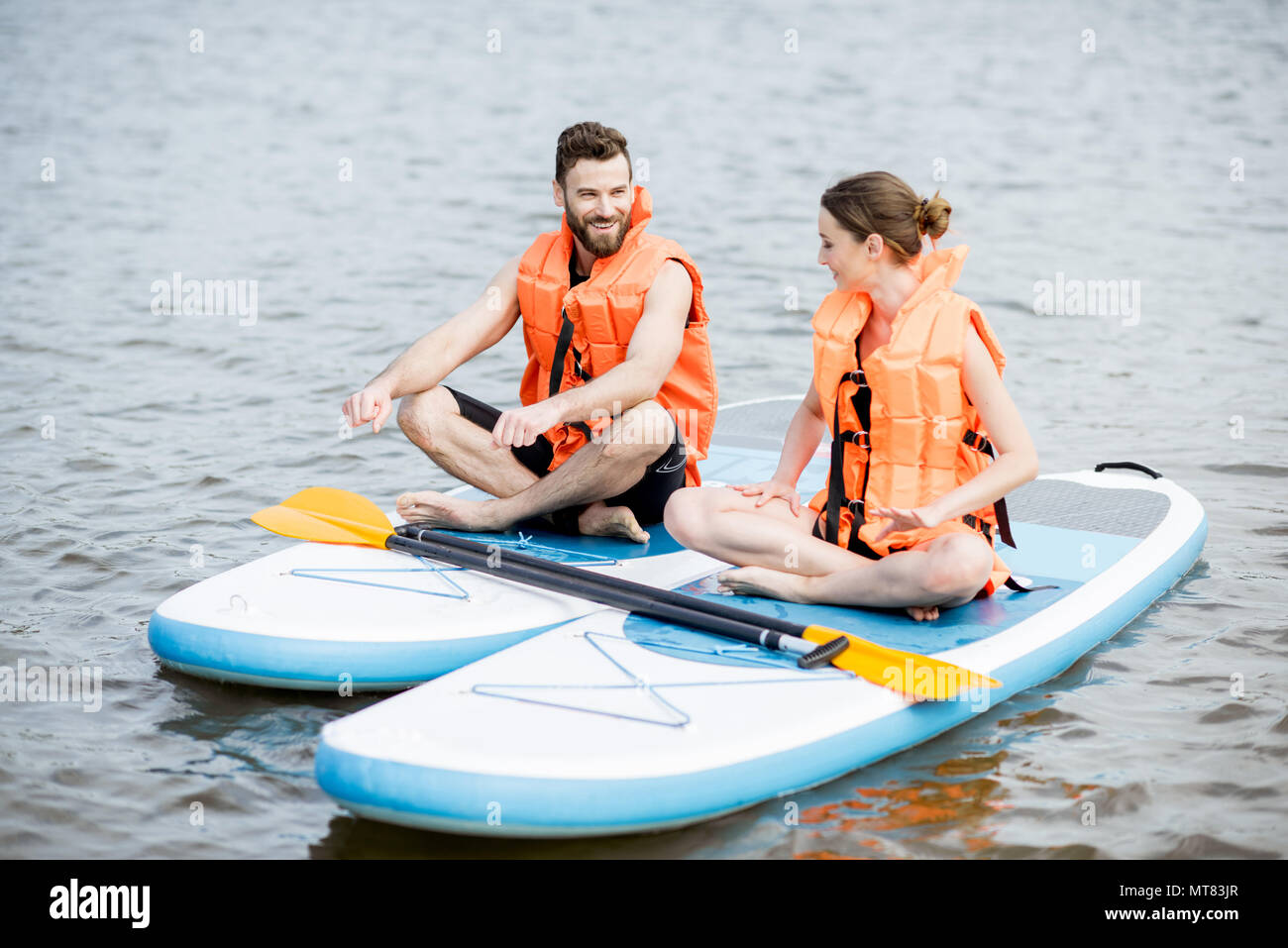 Man sitting on stand up paddleboard hi-res stock photography and images ...
