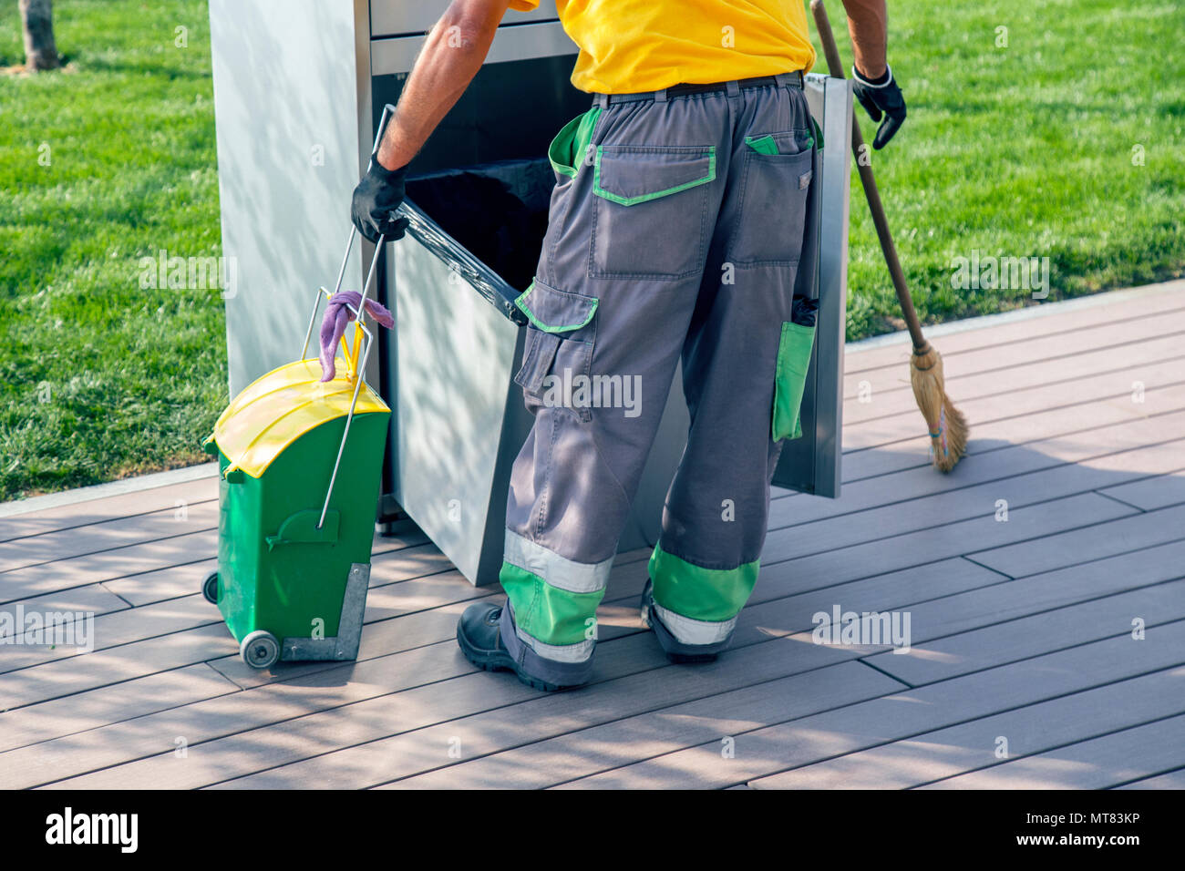 Garbage men emptying trash bin at residential street Stock Photo - Alamy