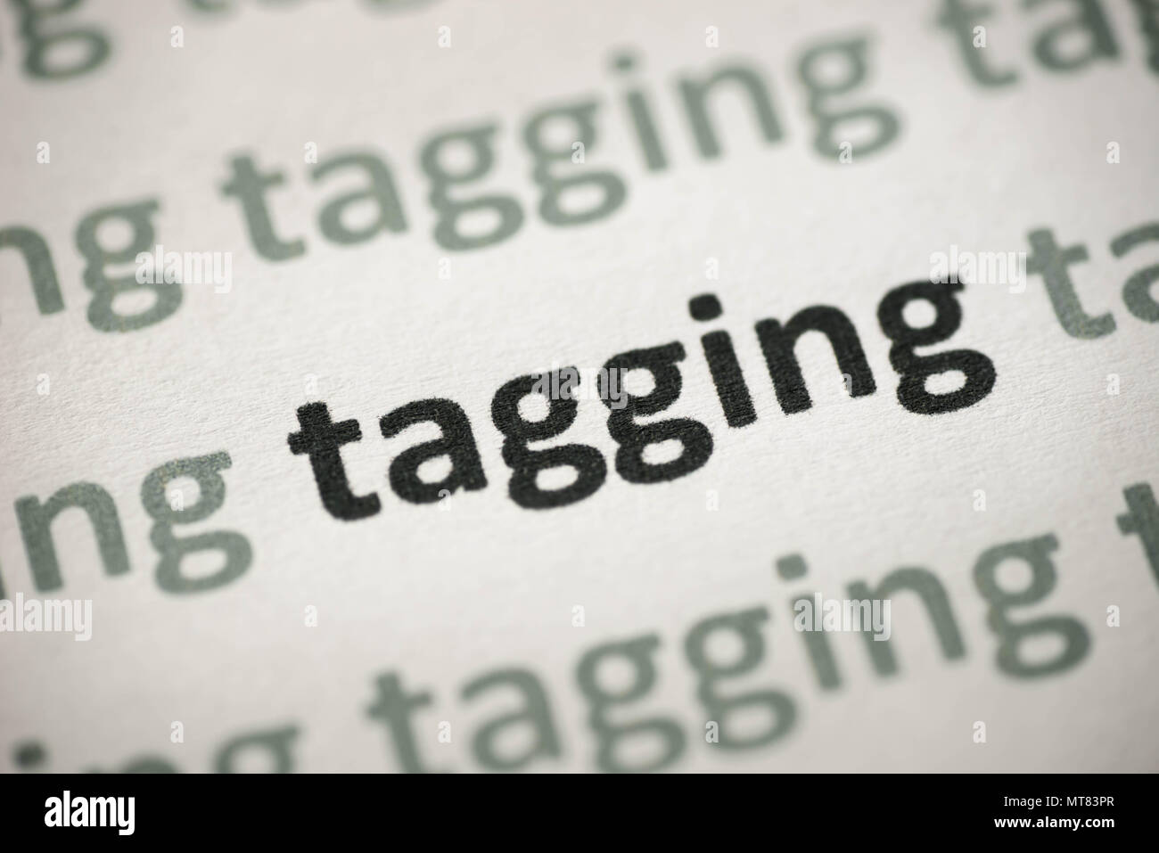 word tagging printed on white paper macro Stock Photo - Alamy