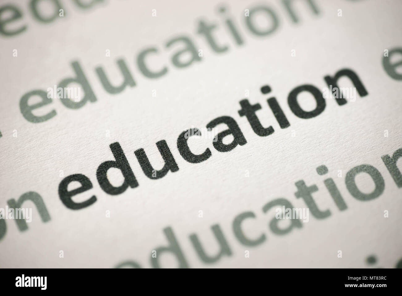 word education printed on white paper macro Stock Photo - Alamy