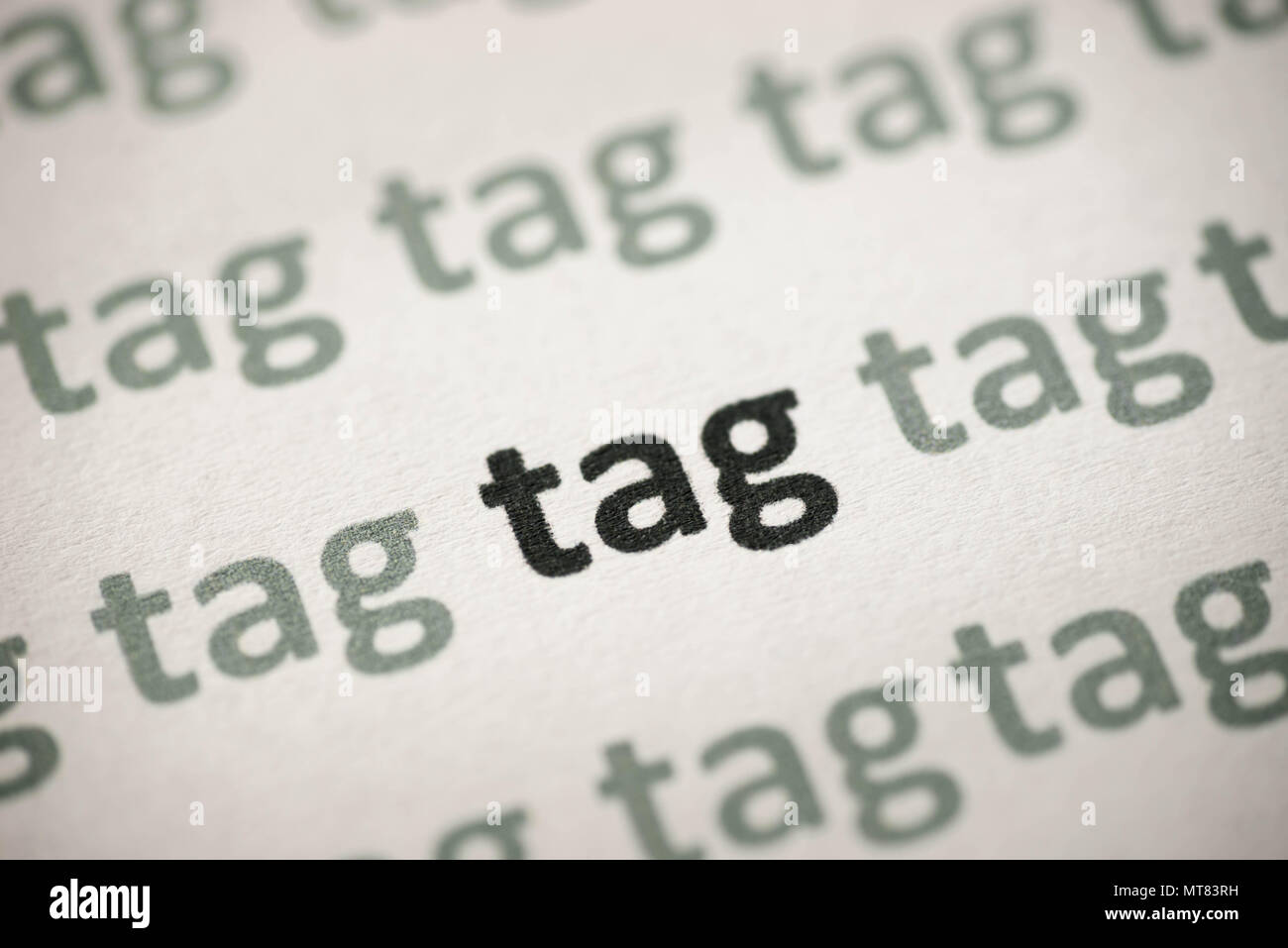 word tag printed on white paper macro Stock Photo - Alamy