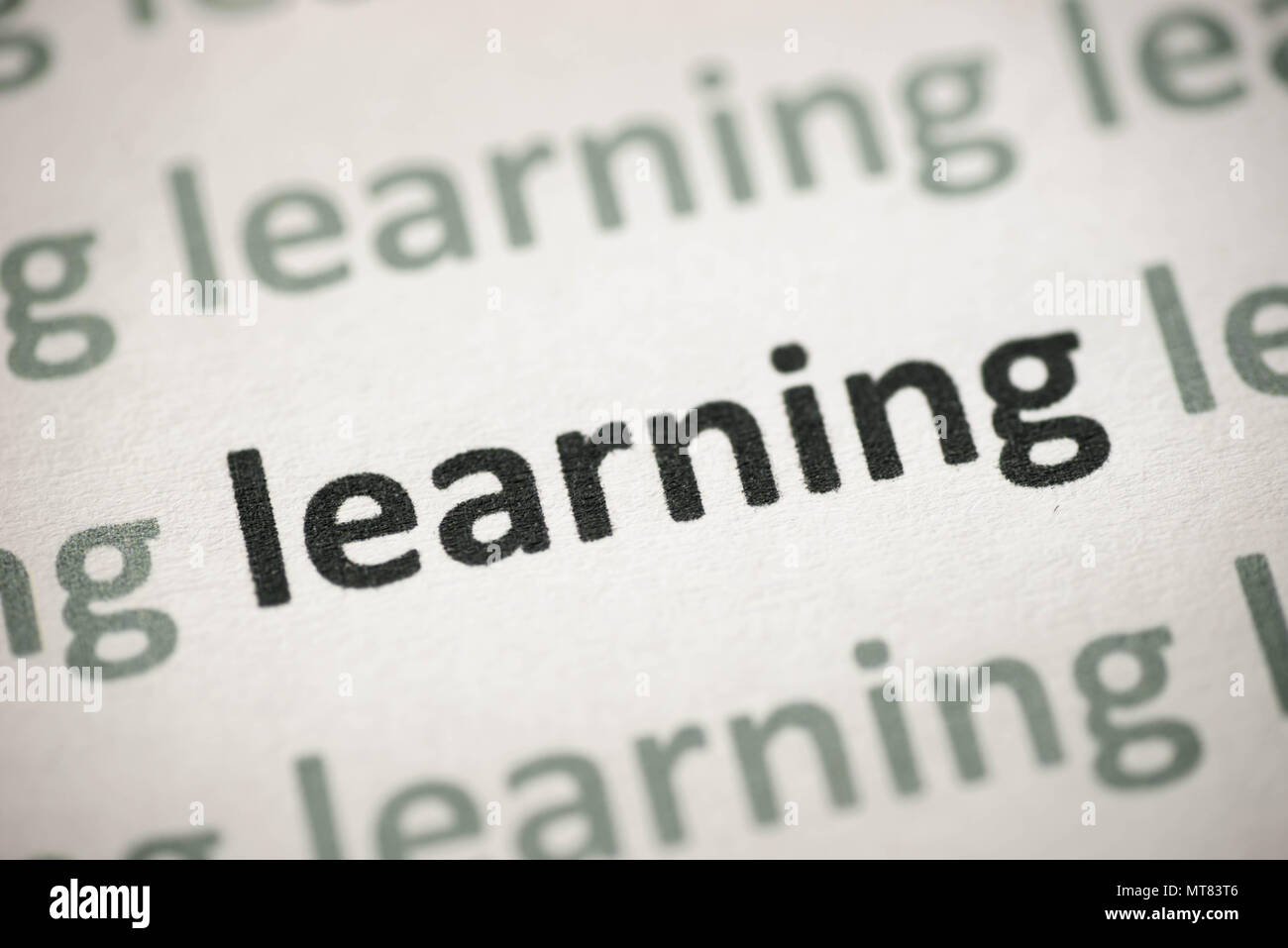 word learning printed on white paper macro Stock Photo - Alamy