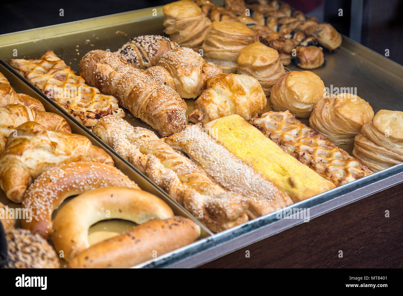 Pastries and variety of baked goods in a bakery window display ...