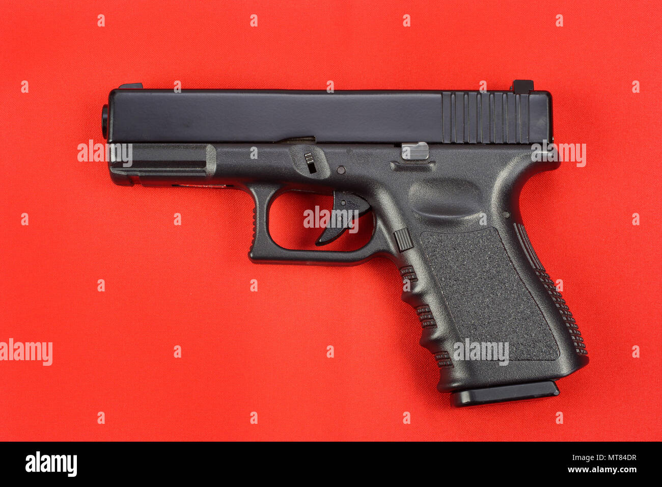 weapon on red background Stock Photo - Alamy