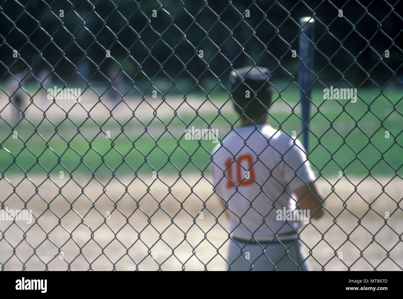 1988 HISTORICAL MALE AMATEUR BASEBALL PLAYER ON FIELD THROUGH CHAIN ...
