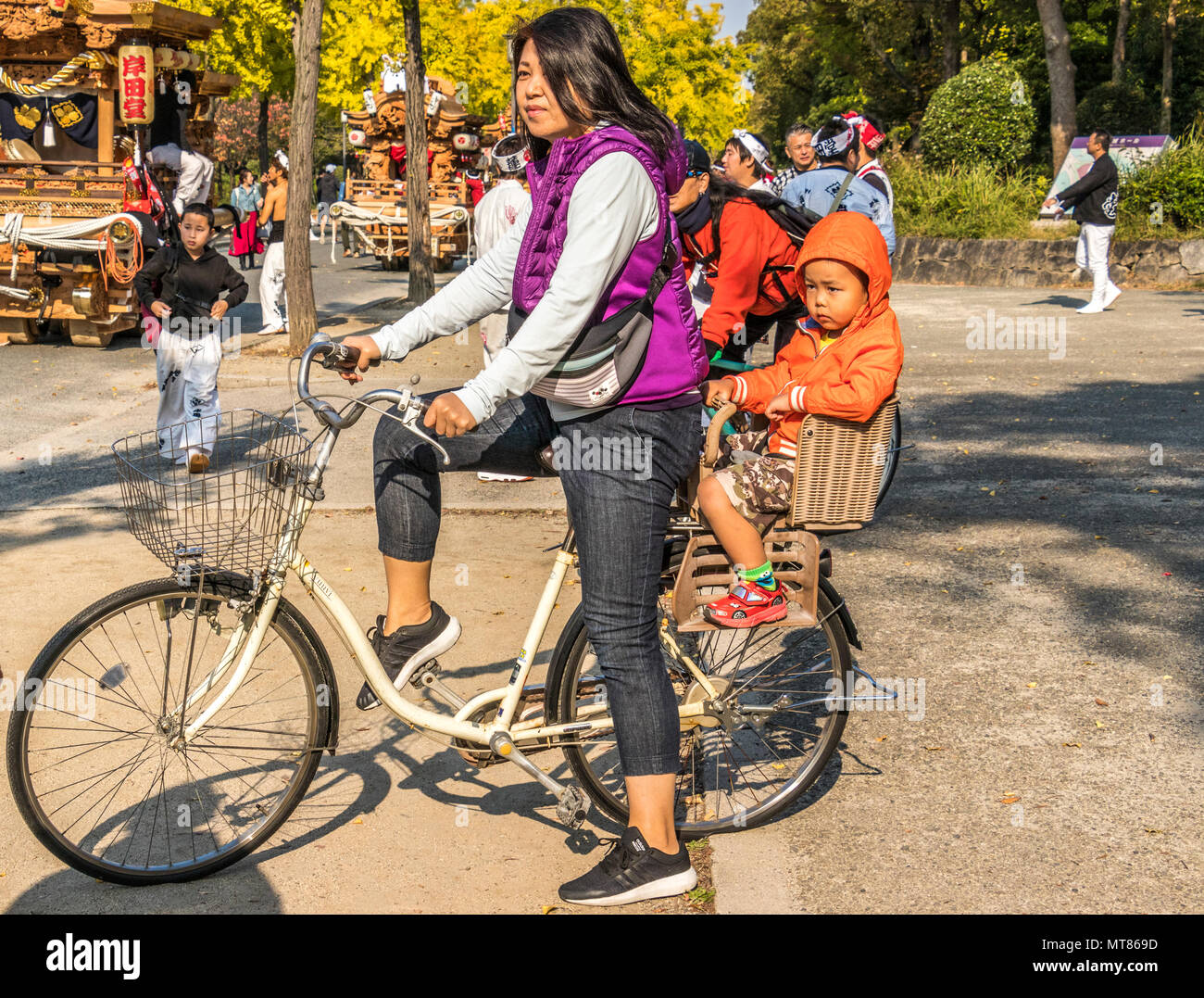 Families with small children cycling in Osaka Castle Park Osaka Japan ...