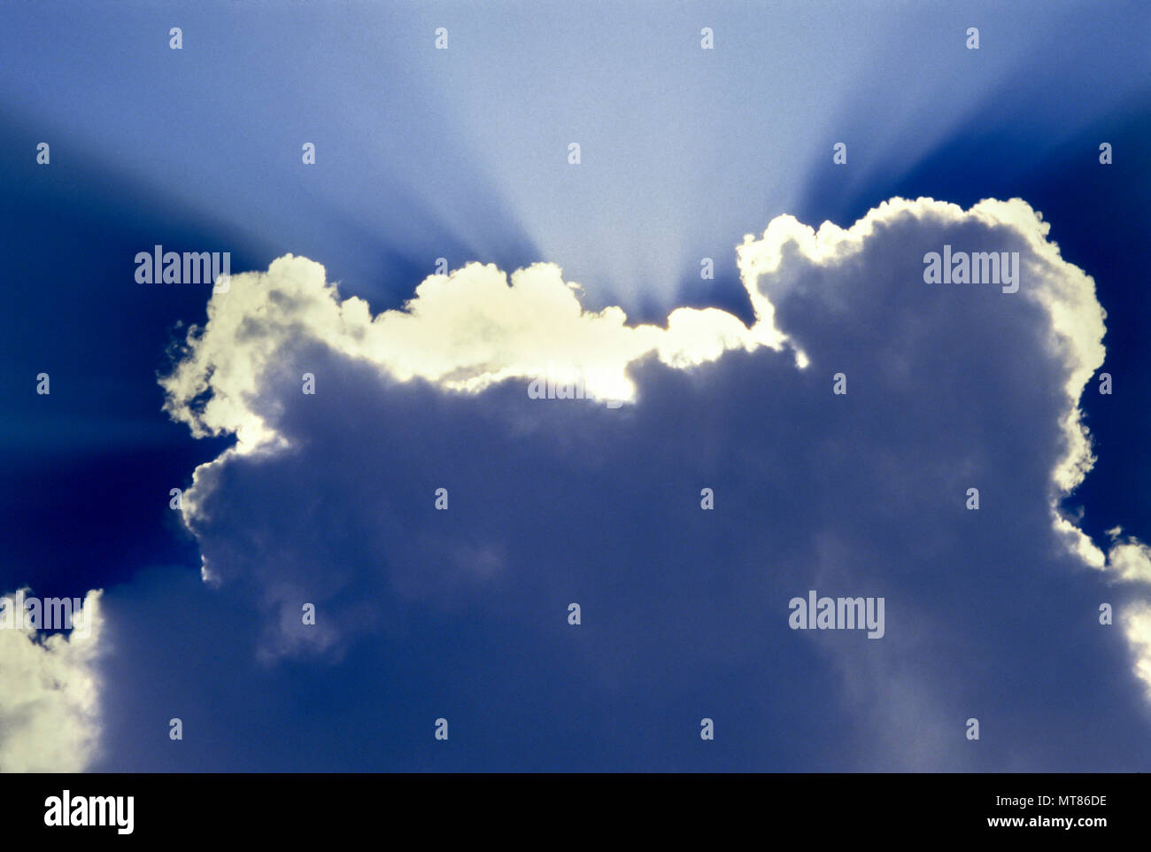 1988 HISTORICAL SUN RAYS ABOVE PUFFY WHITE CLOUD Stock Photo - Alamy