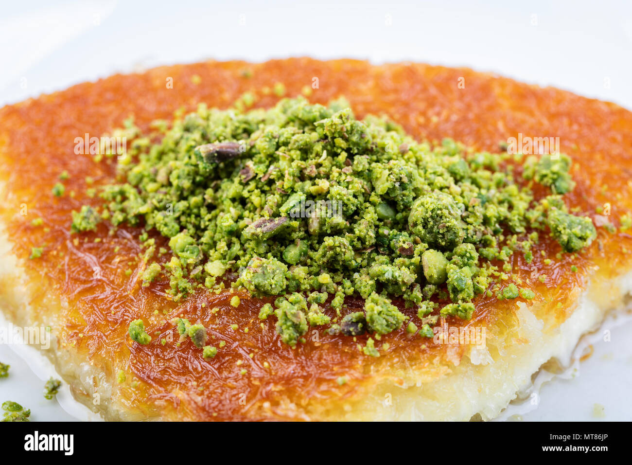 Turkish dessert kunefe, kunafa, kadayif with pistachio powder and ...