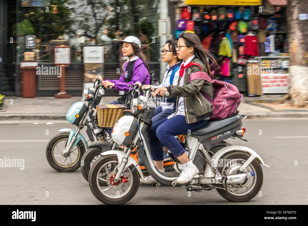 Vietnamese teenagers riding battery powered scooters in Hanoi Vietnam ...