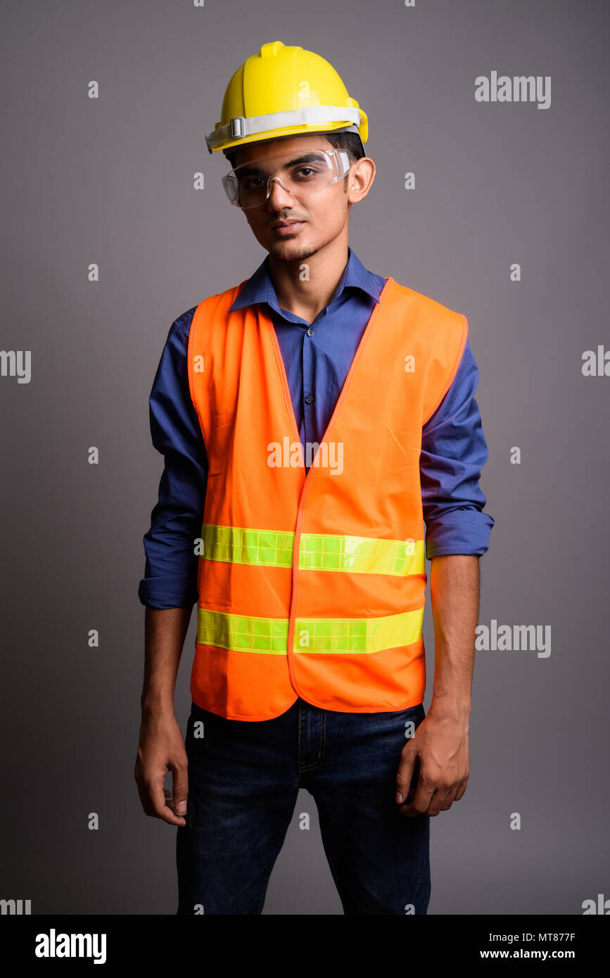 Young Indian man construction worker wearing protective glasses Stock ...