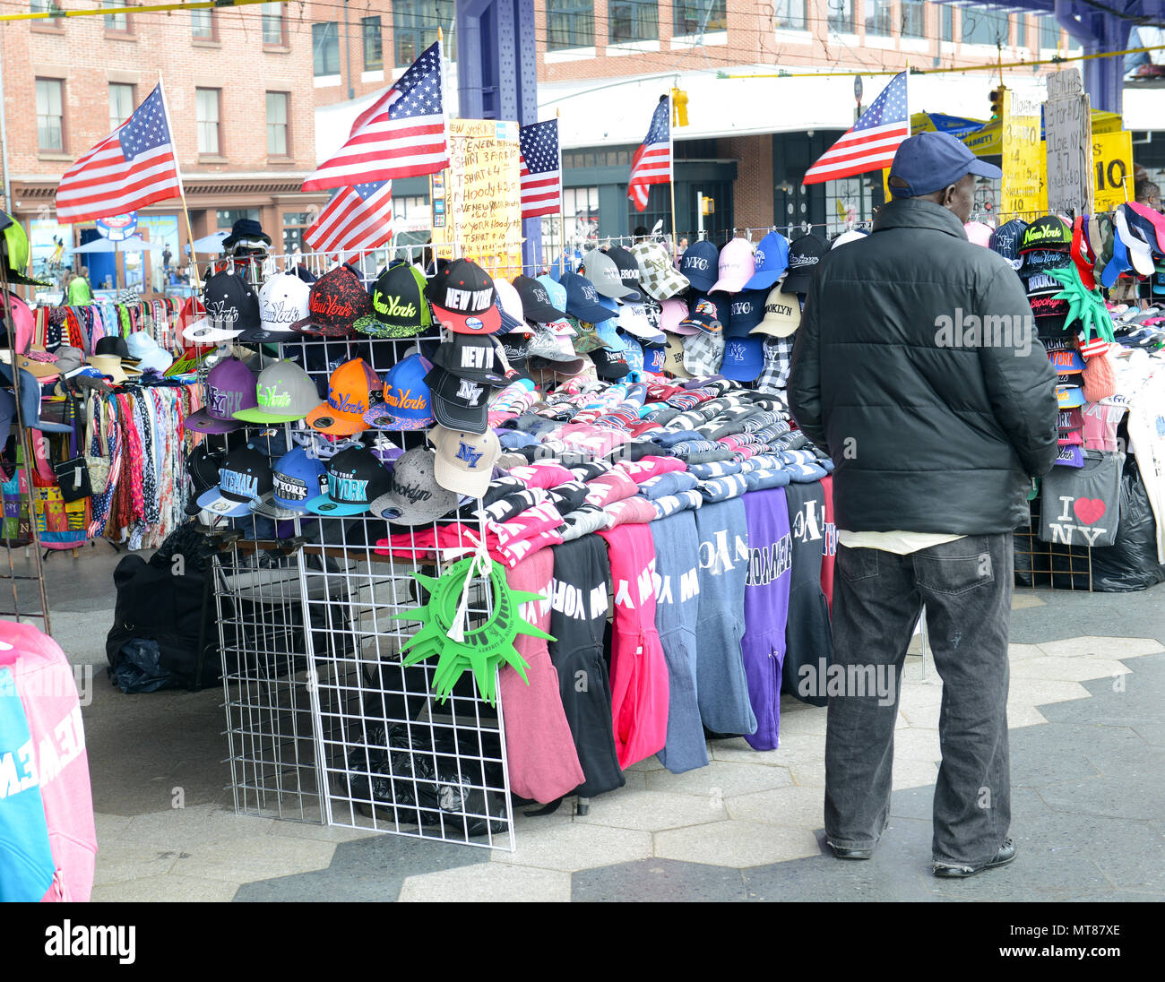Street vendors selling various New York themed souvenirs are part of ...