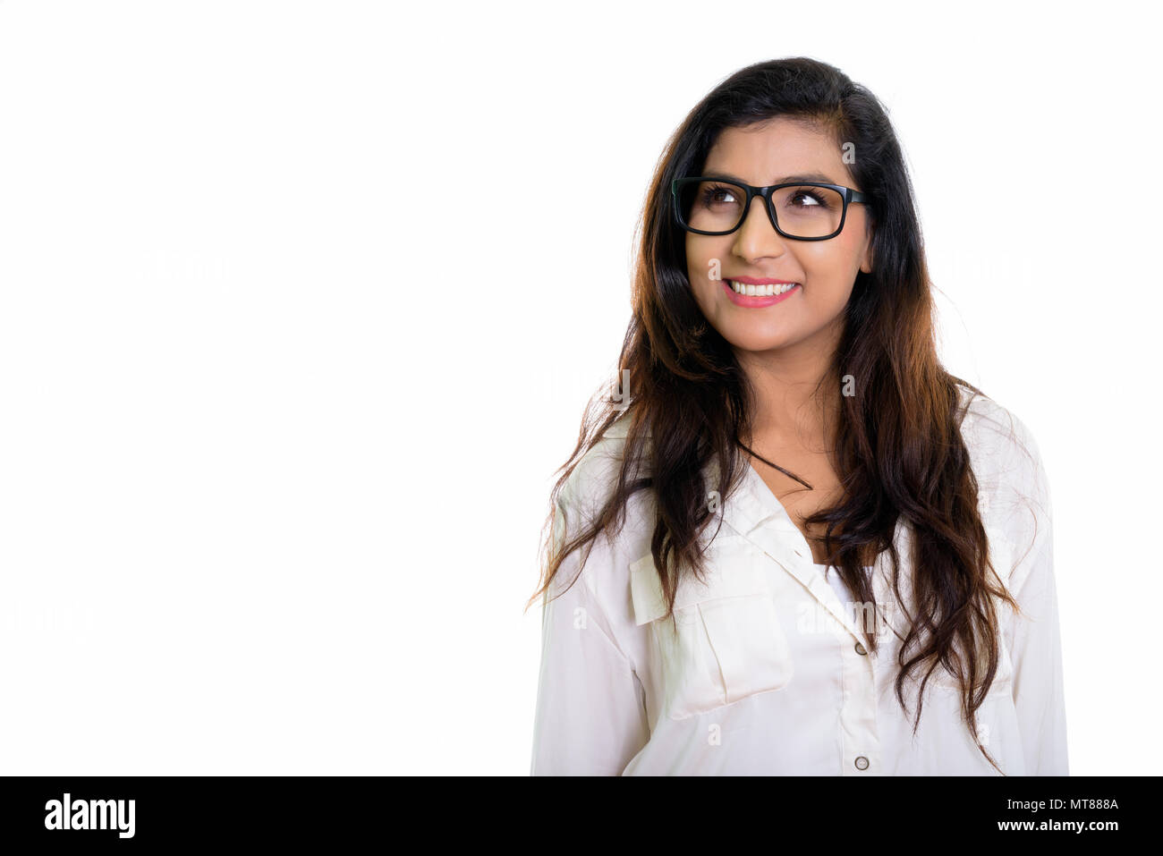 Studio shot of young happy Persian woman smiling and thinking wi Stock ...