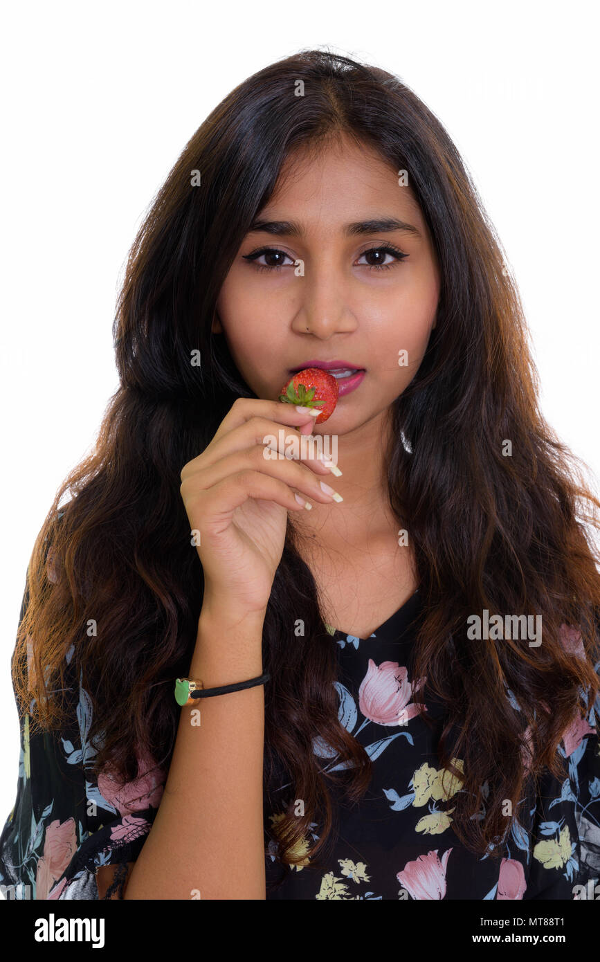 Face of young beautiful Persian woman eating strawberry isolated Stock ...