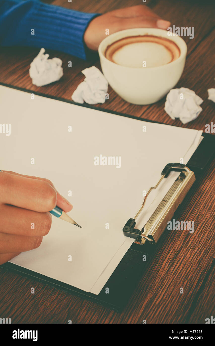 Human hand use pencil write on blank paper with cup of cappuccino ...