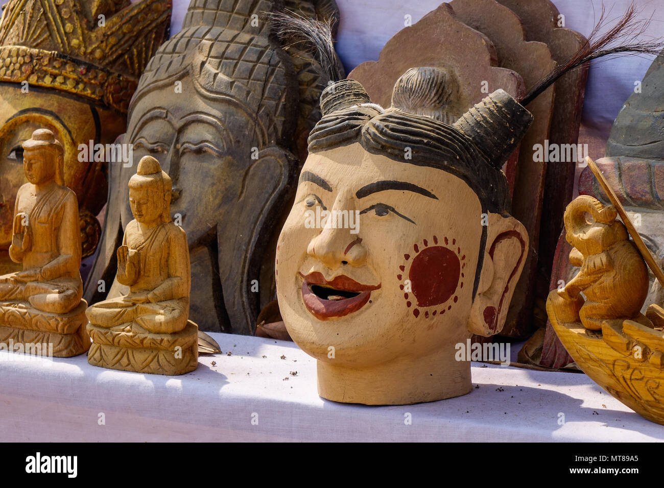 Souvenirs (wooden statues) for sale at the shop in Mandalay, Myanmar ...