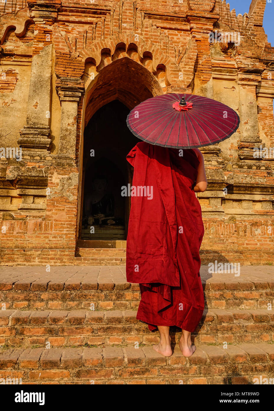 A young monk standing at Buddhist pagoda in Bagan, Myanmar Stock Photo ...