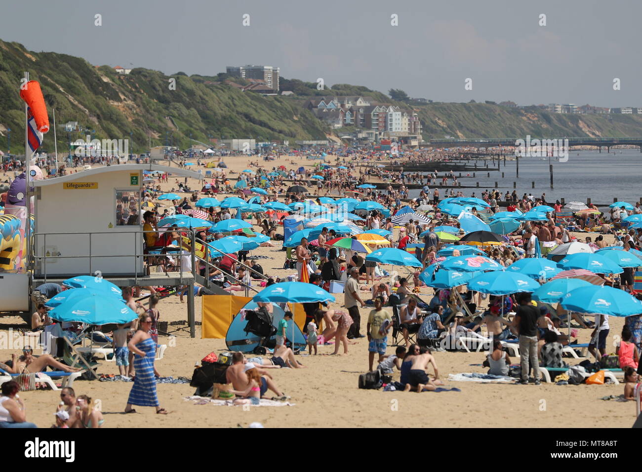 People enjoy the hot weather on Bournemouth Beach, in Dorset, as ...