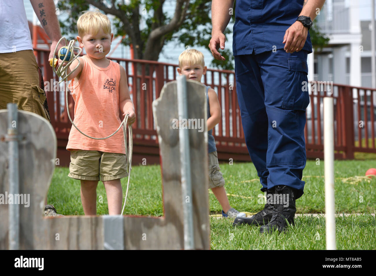 A child practices throwing a heaving line with crew members from Coast ...