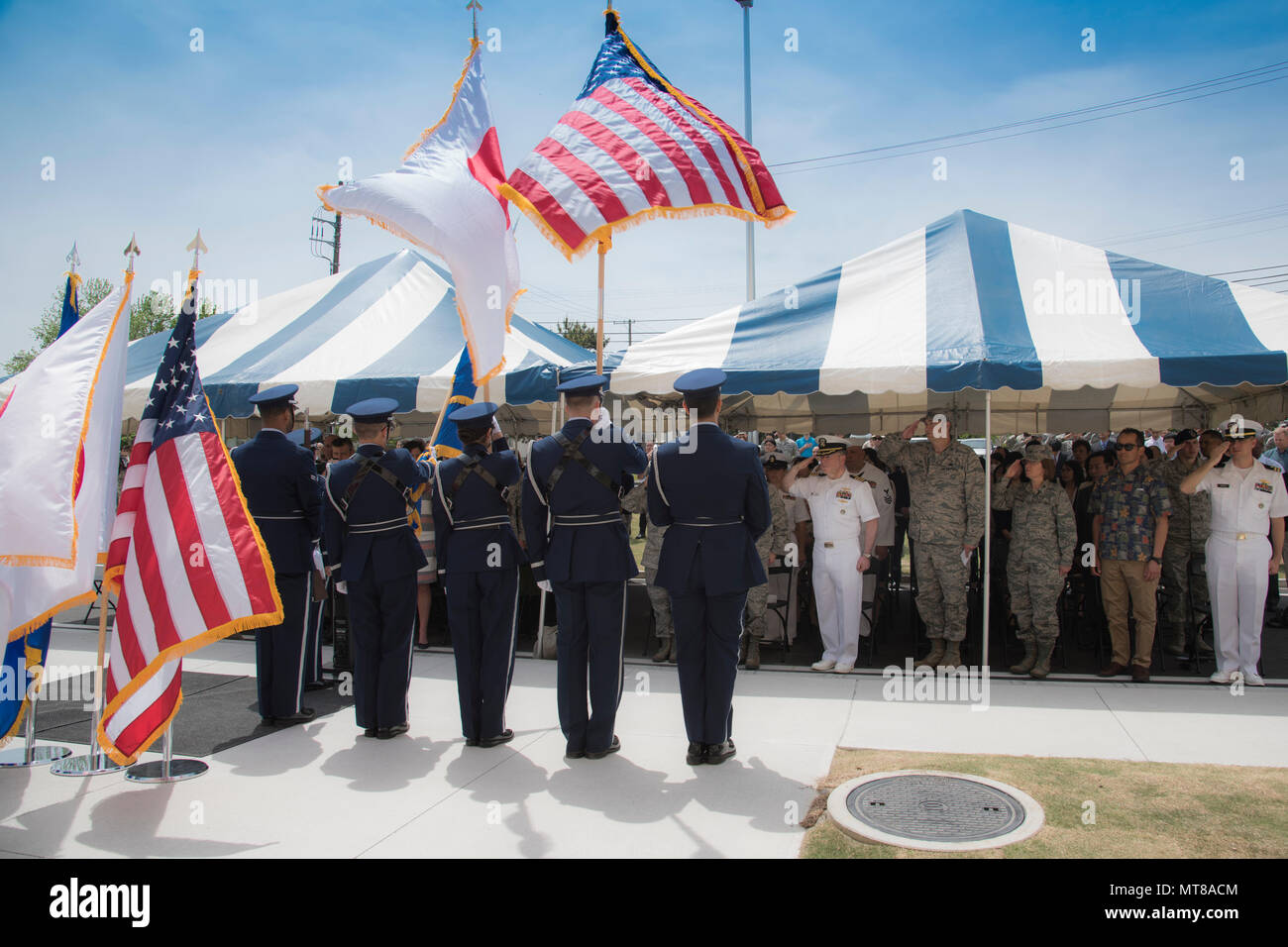 Base Honor Guard members hoist the colors for the singing of the ...