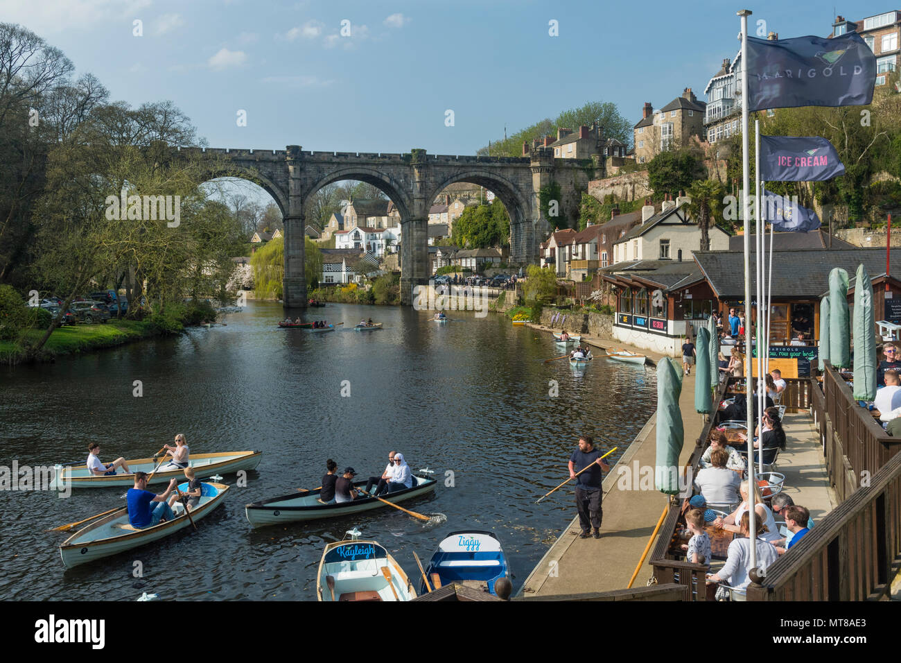 Blue sky & people relaxing by bridge at riverside cafe & boating in ...