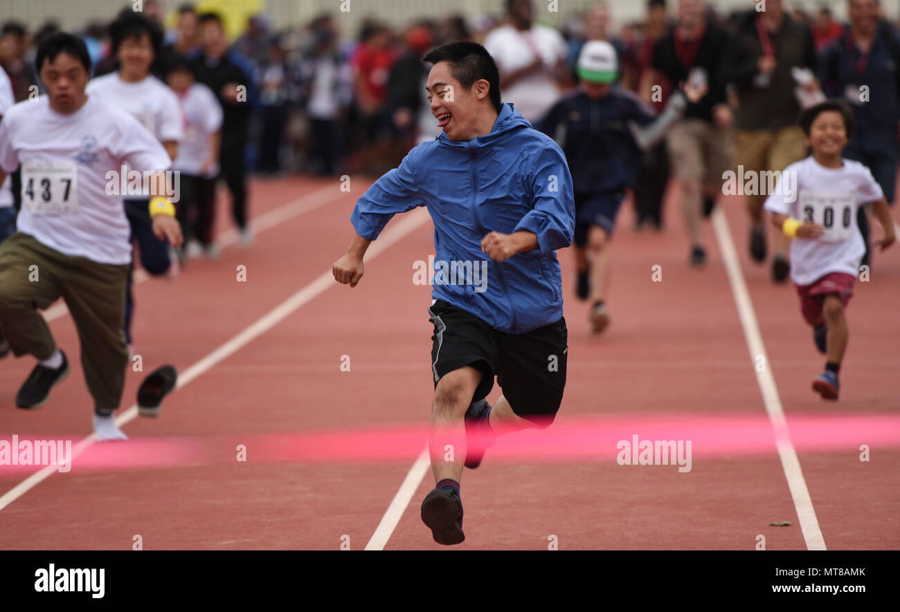 Participants race toward the finish line during the 50 meter dash at ...