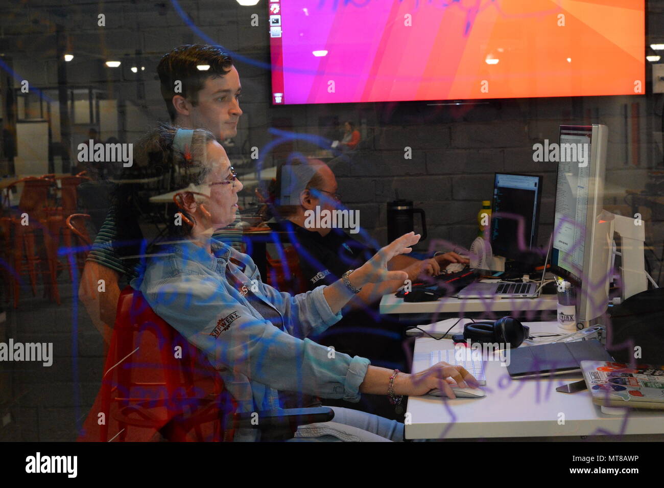 Tracey Birch, Michael Gleason and Ian Blenke, members of the SOFWERX data science team, develop ...