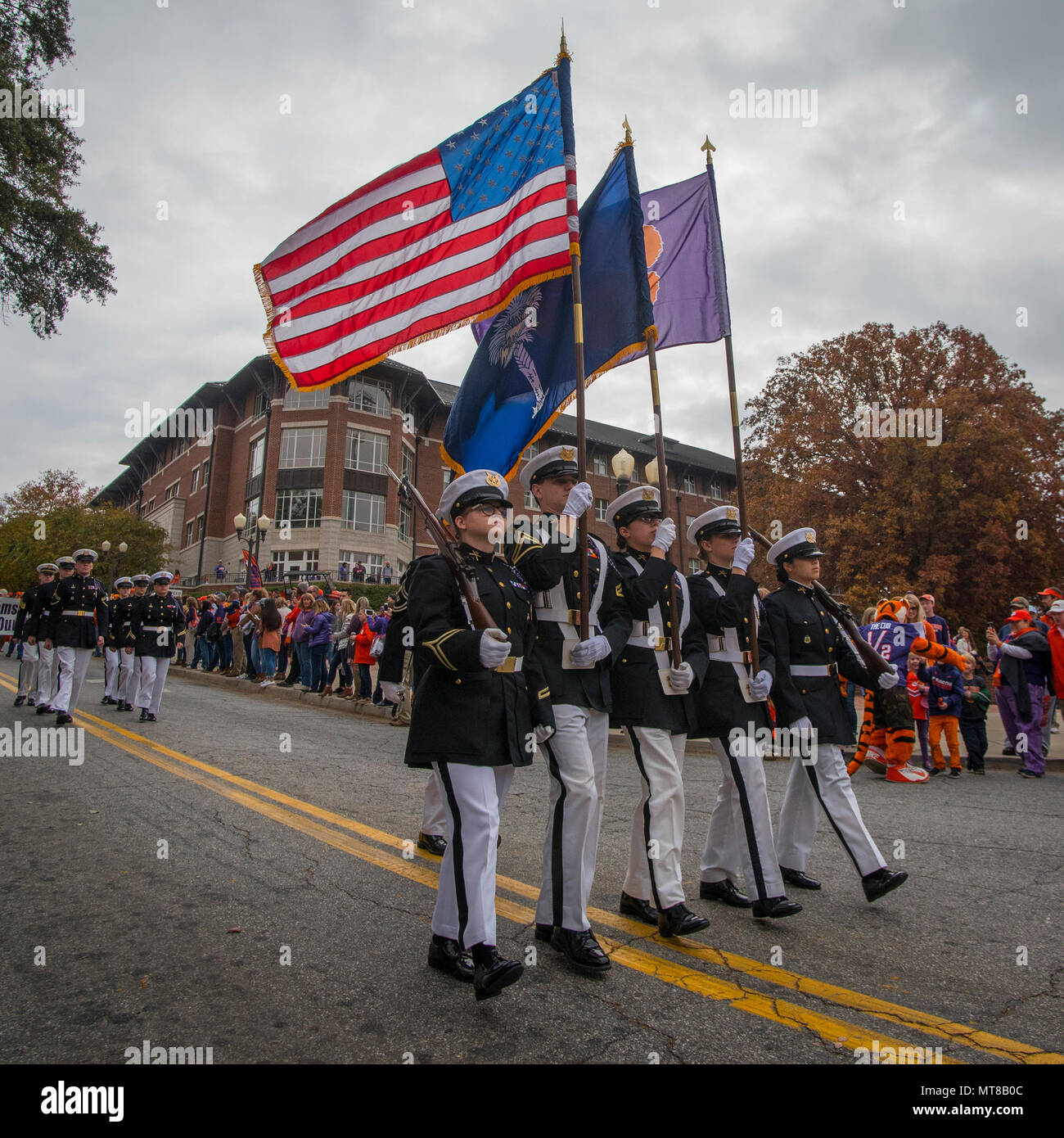 The Clemson University Pershing Rifles honor guard lead the parade into ...