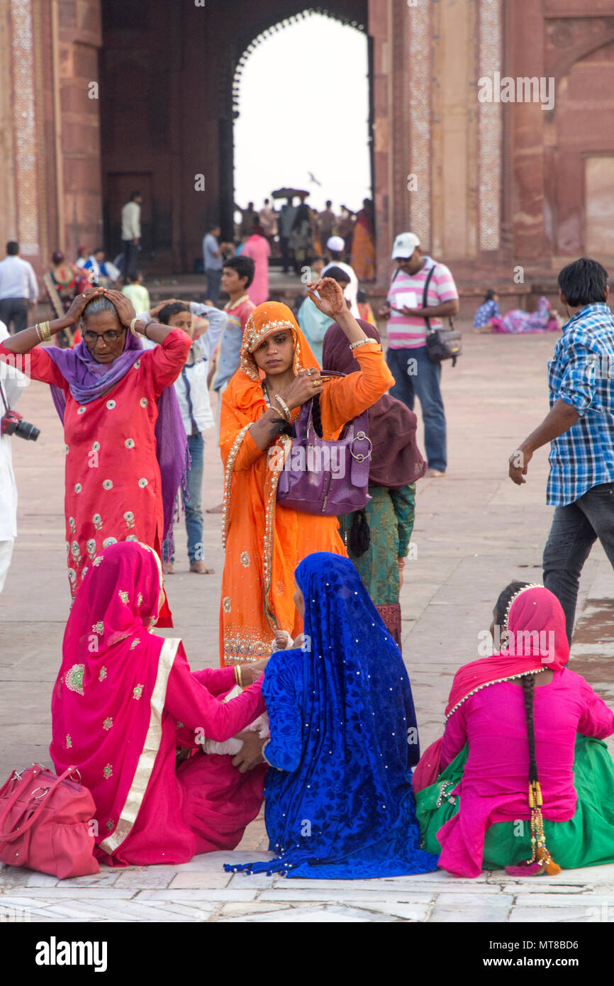 Visitors wear brightly colored clothing at the Jama Masjid, Fatehpur ...