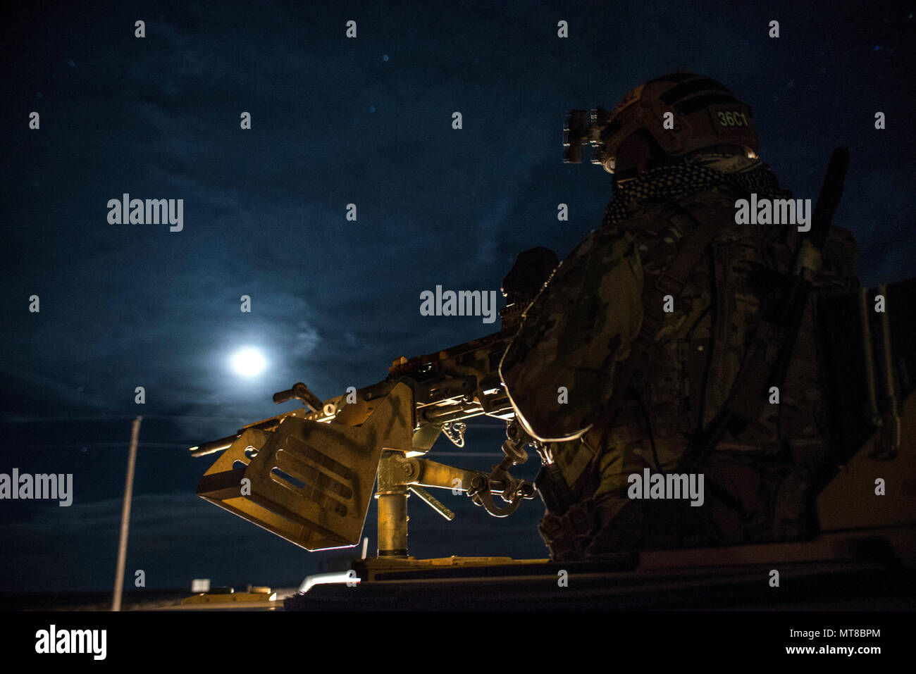 A member of the U.S. military mans the gun of a armored vehicle during ...