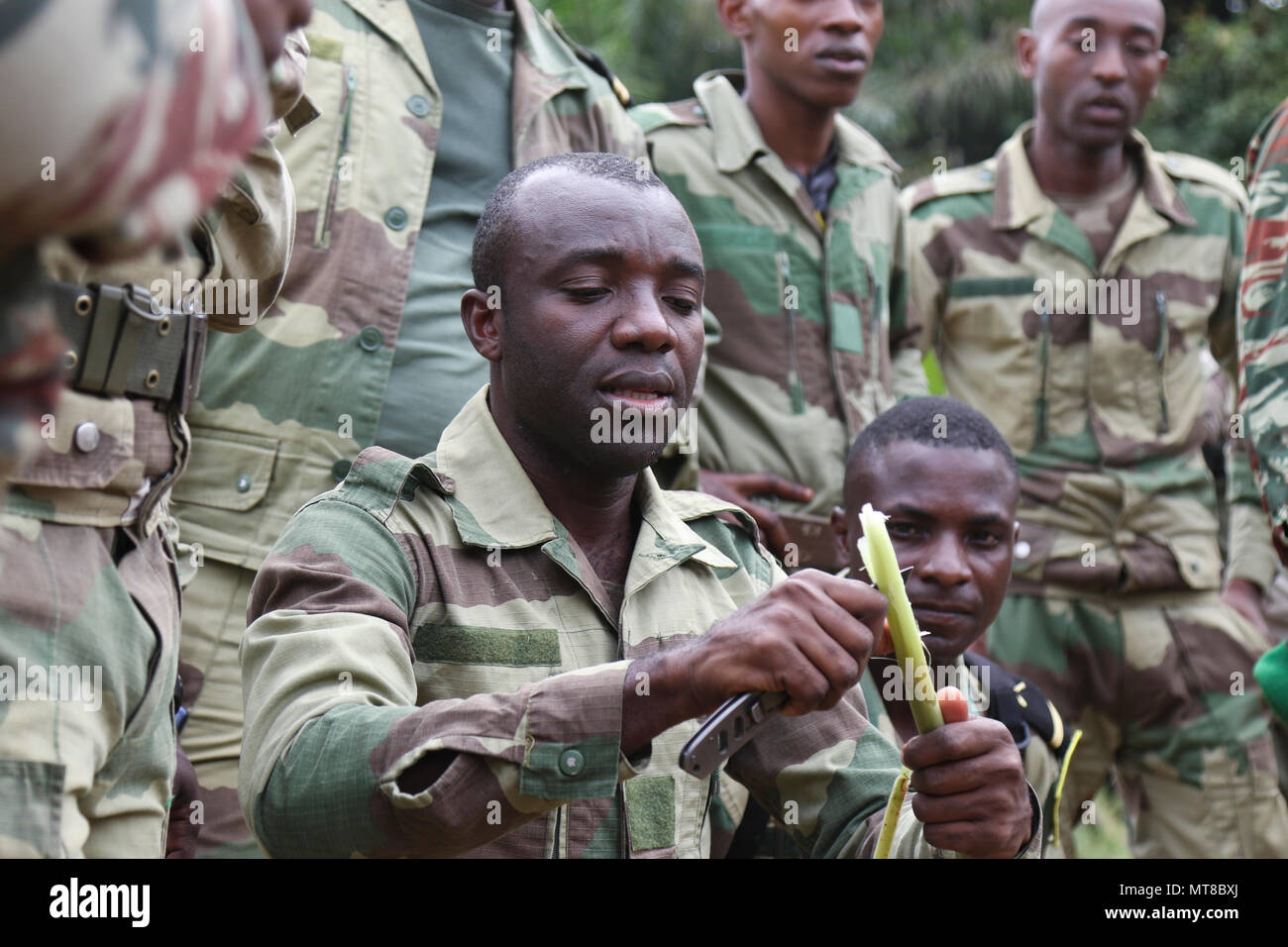 A Gabonese paratrooper, center, shows other members of his Forces de ...