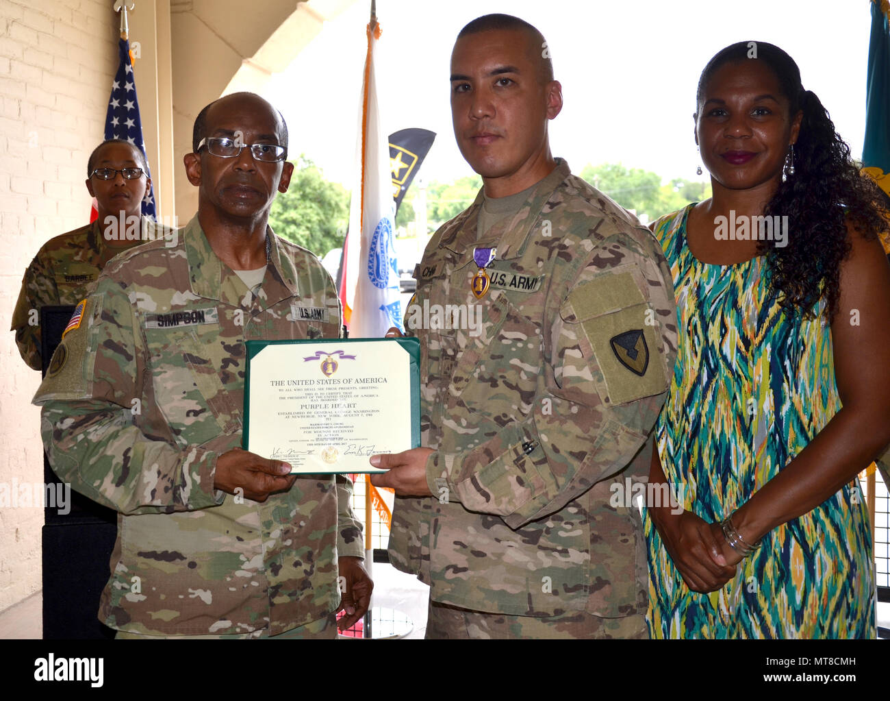 Maj. Gen. James Simpson presents the Purple Heart to Maj. Evan Chung ...