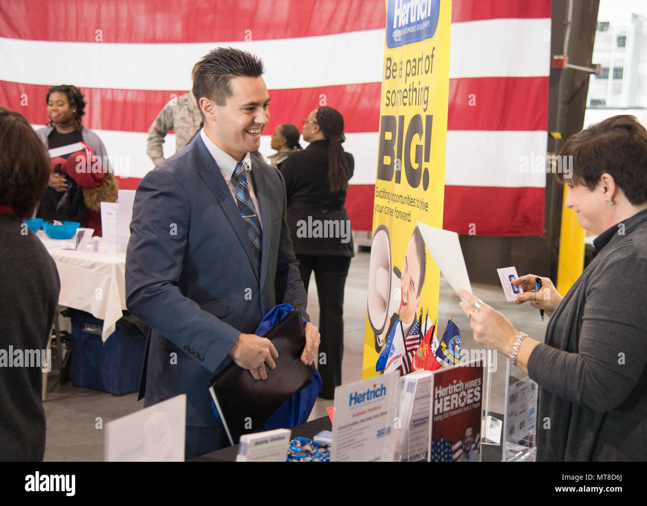 Travis Lockwood hands his resume to a potential employer at the ...