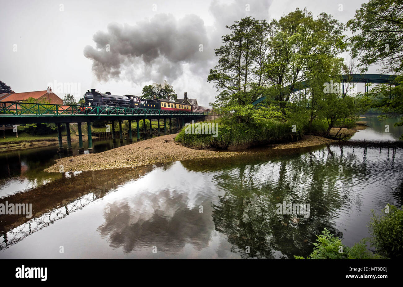 The LNER 1264 steam locomotive passes over the River Esk in Ruswarp on ...