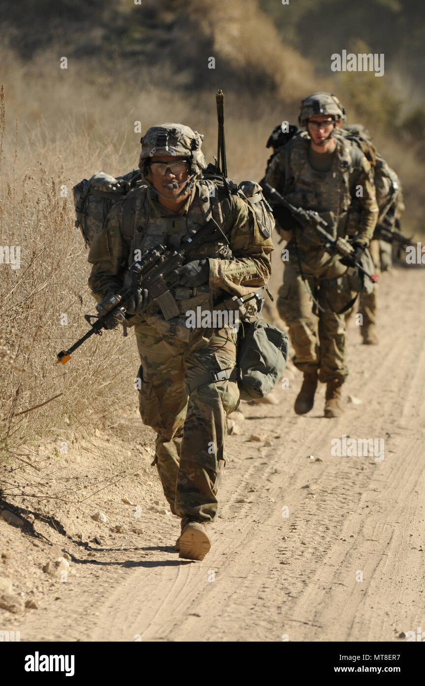 A 5th Battalion, 20th Infantry Regiment, Soldier rucks up a hill during ...