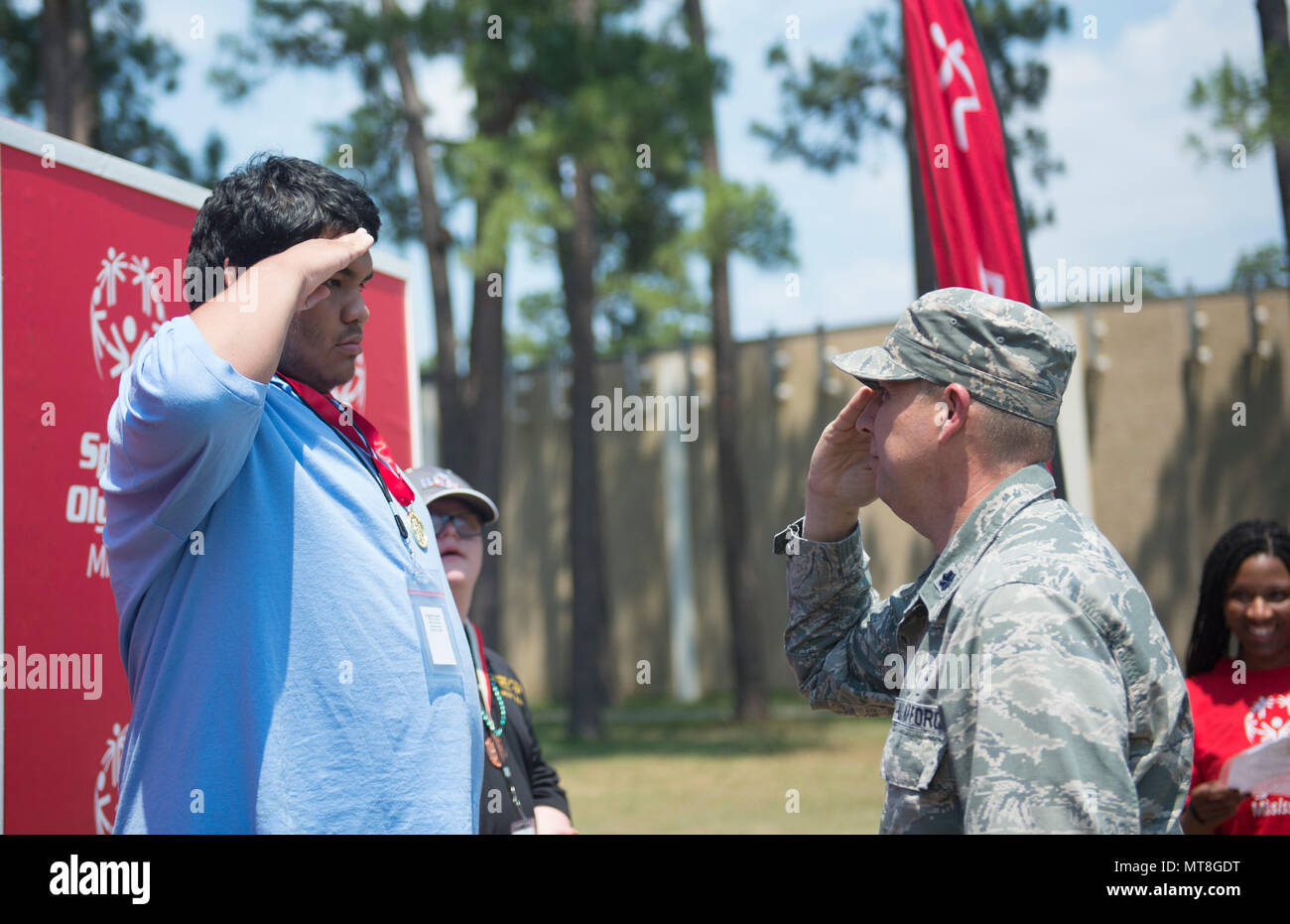 Quentin Comby, Area 18 athlete, salutes Lt. Col. Michael Blowers, 81st ...