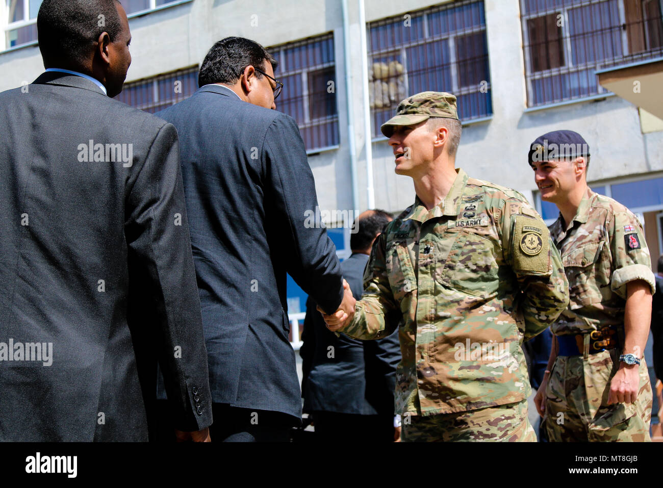 Lt. Col. Adam Lackey (right), Battle Group Poland commander, greets ...