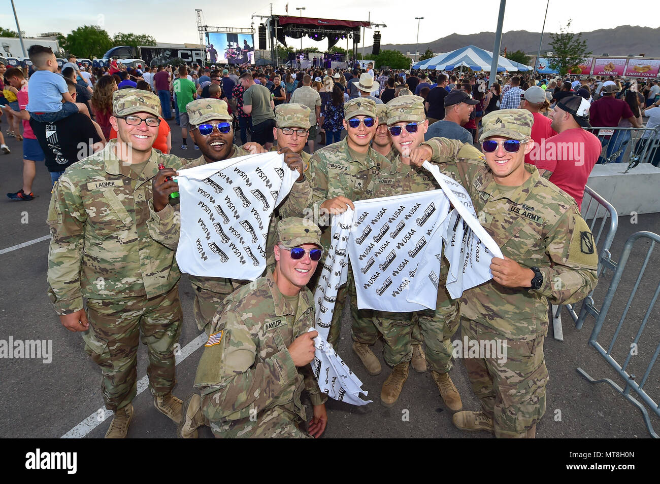 Soldiers pose with BaseFEST free giveaways during the concert at Ft ...