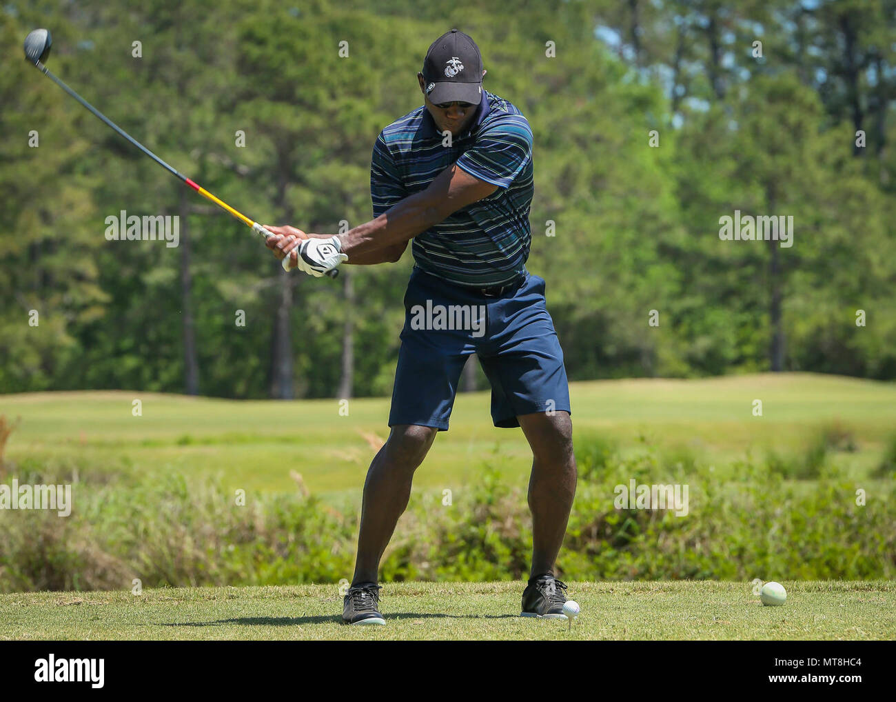 A golfer begins the first hole of a golf tournament aboard Marine Corps ...