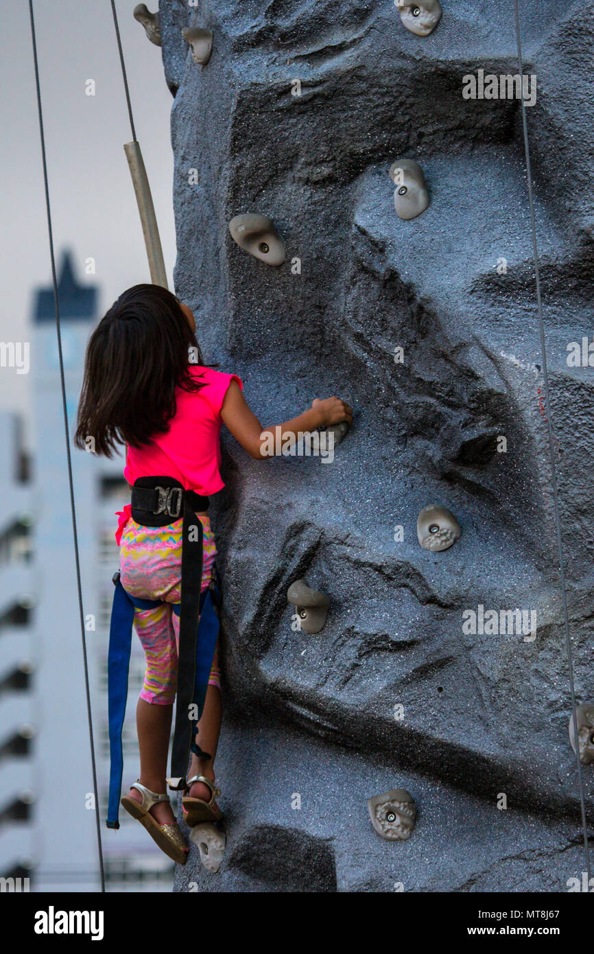 CAMP FOSTER, OKINAWA, Japan – A child climbs to the top of the rock ...