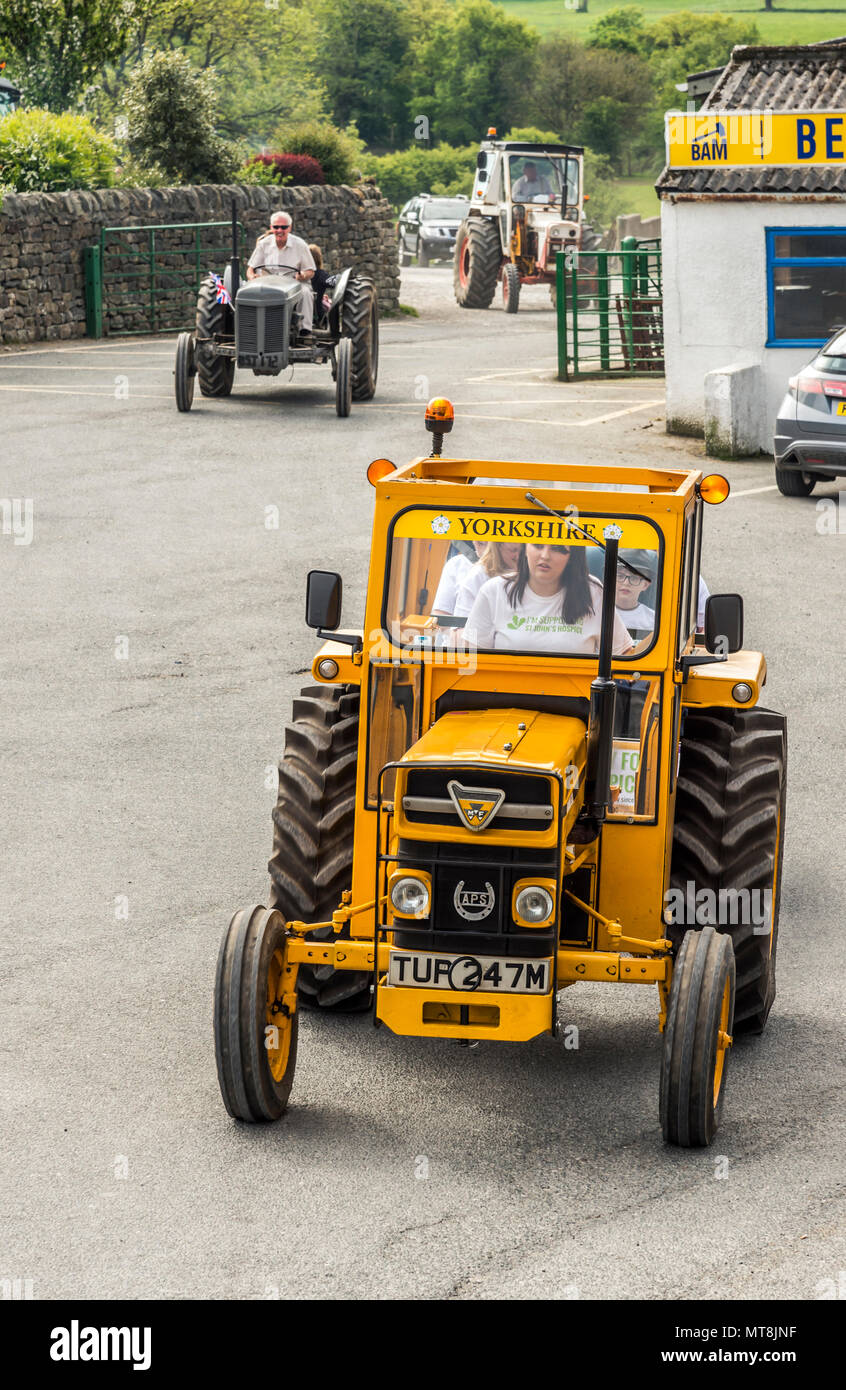 The annual charity vintage tractor rally leaving the live-stock auction ...