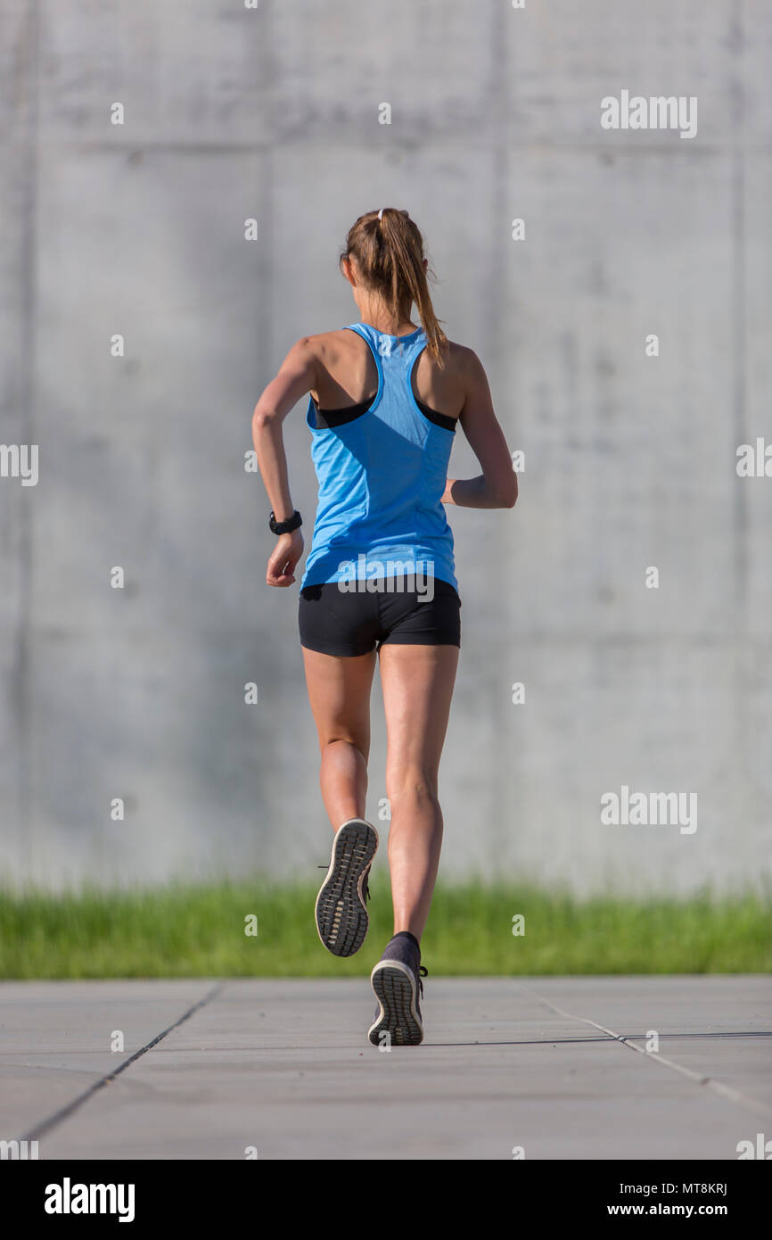 Female Urban Runner running away from viewer Stock Photo - Alamy