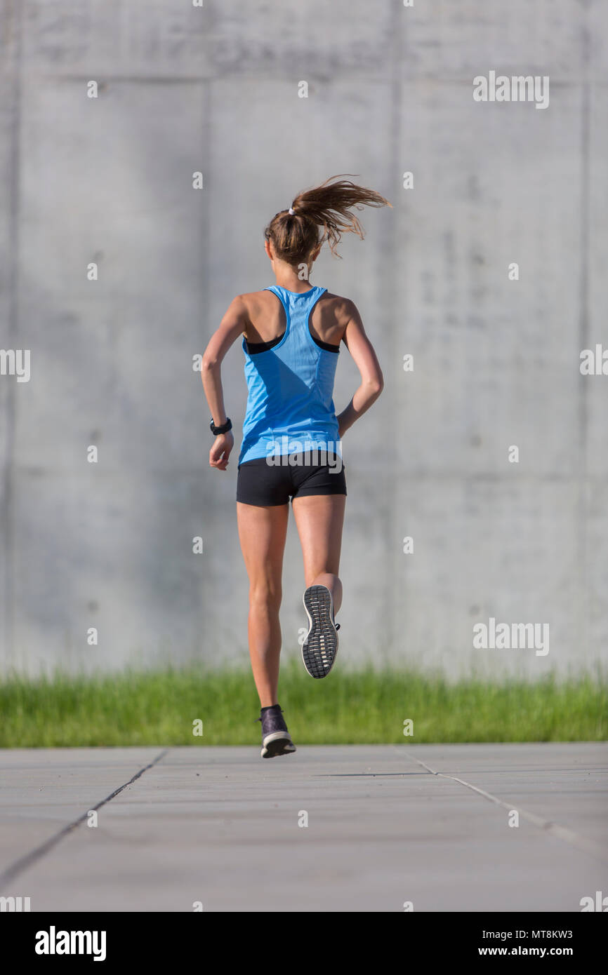 Female Urban Runner running away from viewer Stock Photo - Alamy