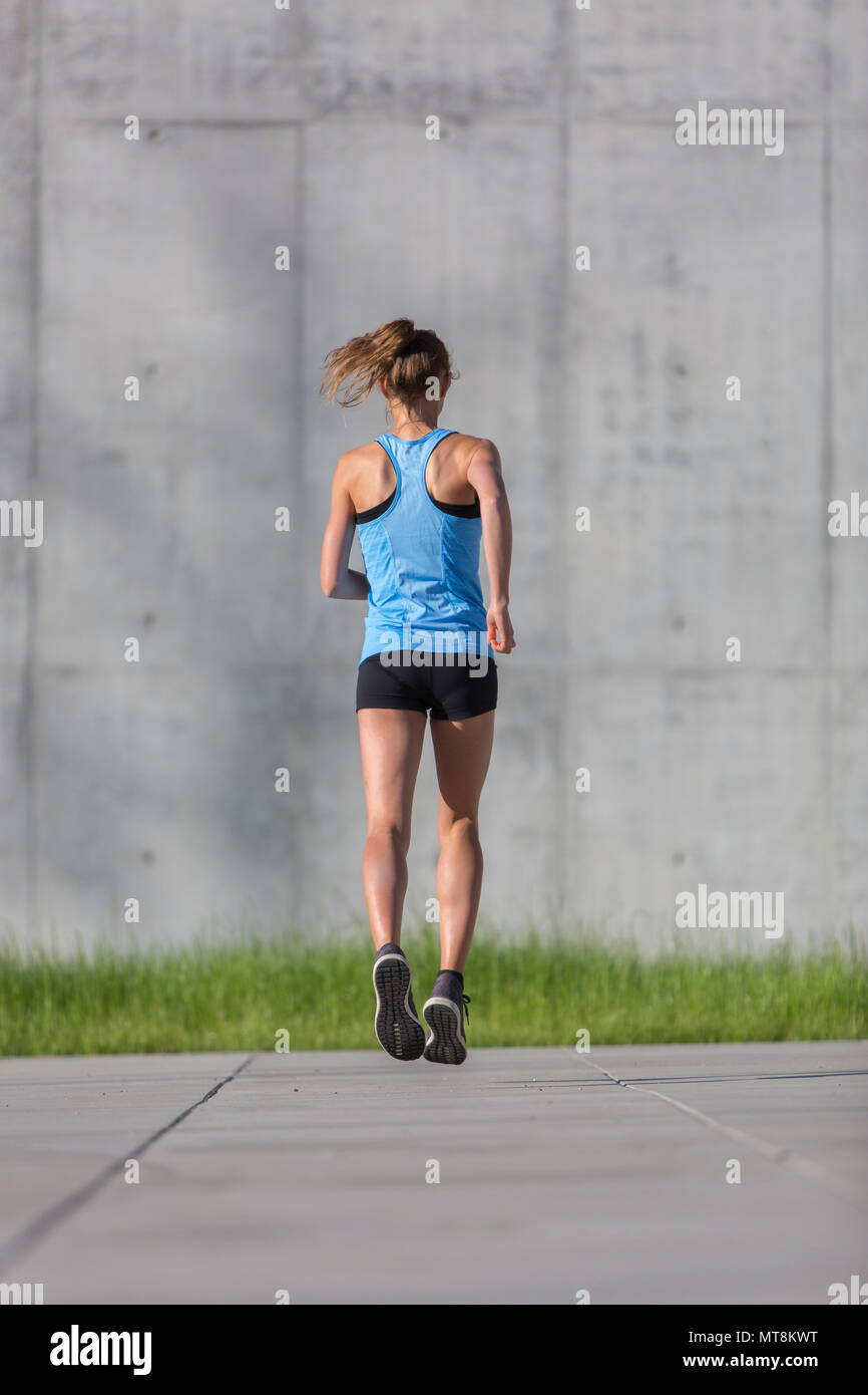 Female Urban Runner running away from viewer Stock Photo - Alamy