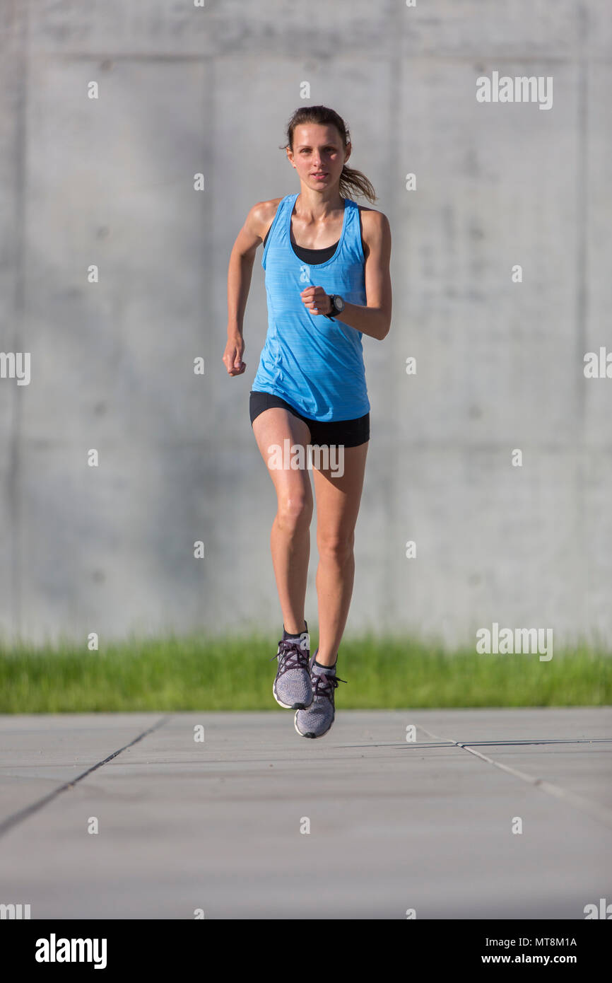 Female Urban Runner running toward the viewer Stock Photo - Alamy