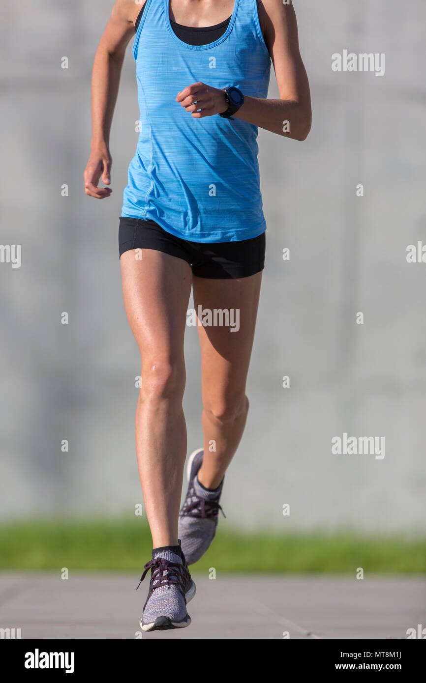 Female Urban Runner running toward the viewer Stock Photo - Alamy
