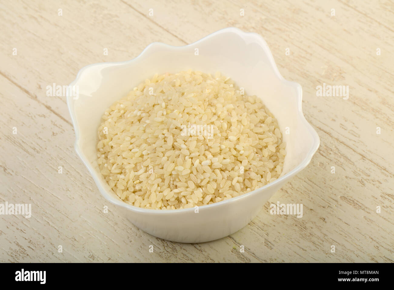 Raw rice heap in the bowl - ready for cooking Stock Photo - Alamy