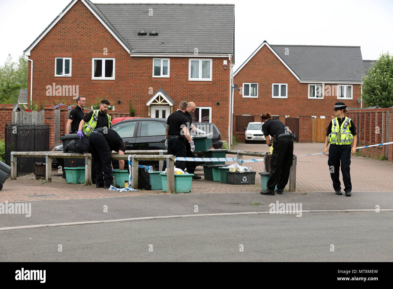 Police officers search recycling bins scene hi-res stock photography ...