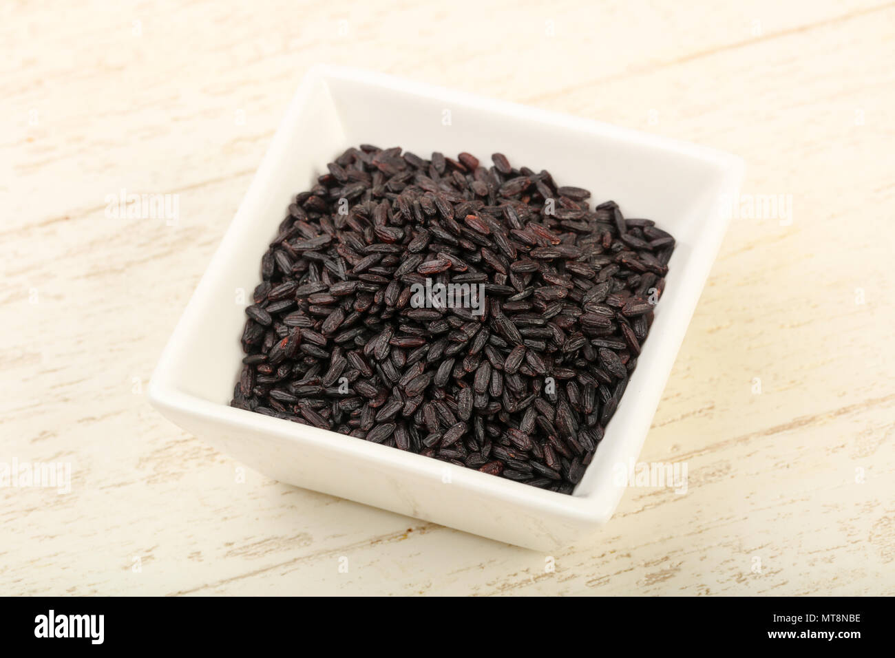 Black wild rice in the bowl over wooden background Stock Photo - Alamy