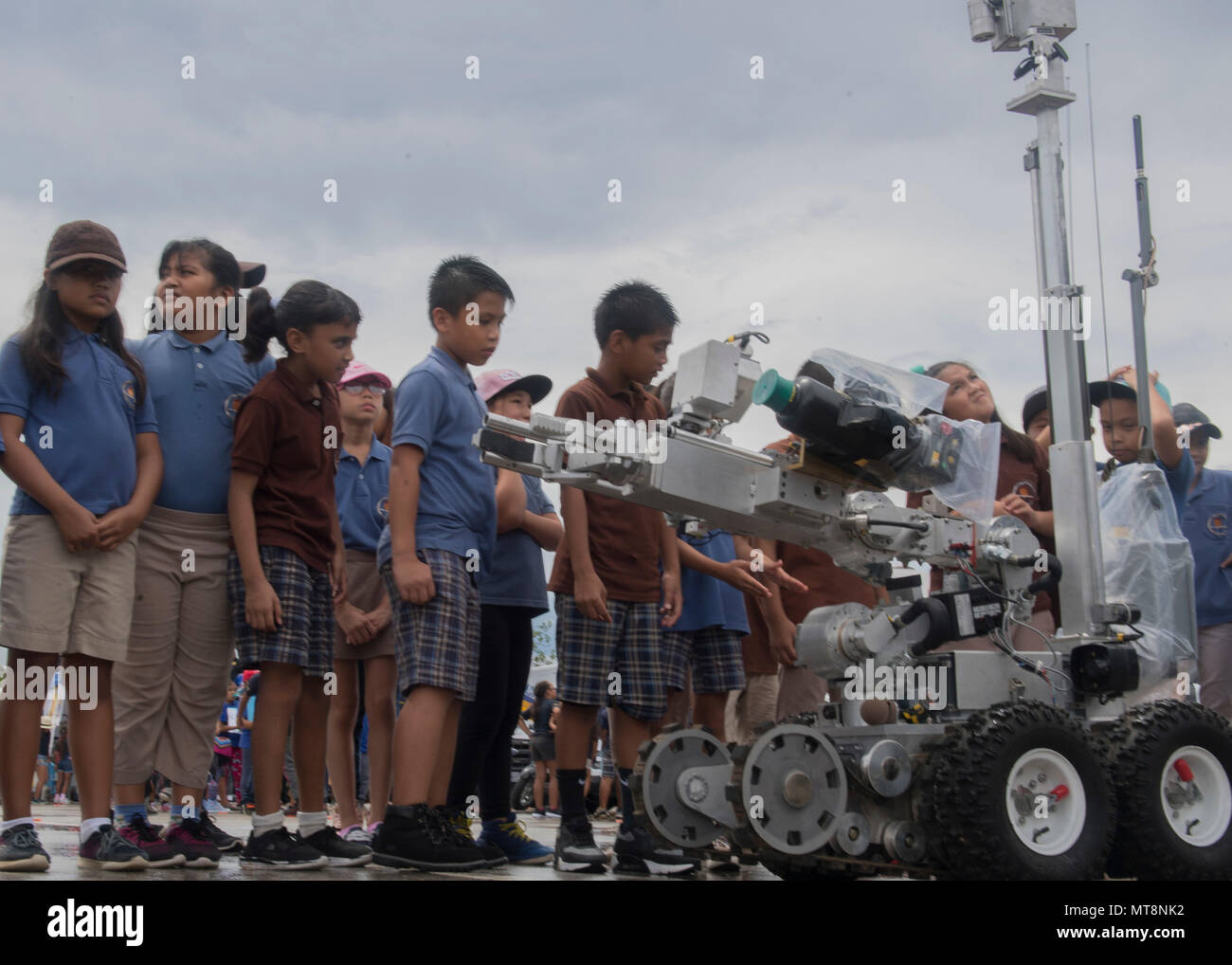 180517-N-MZ078-1109 Schoolchildren observe a remote control military ...